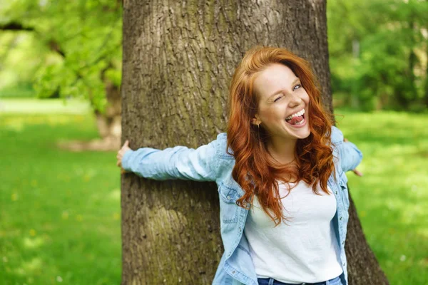 Precocious young redhead woman winking - Stock Image - Everypixel