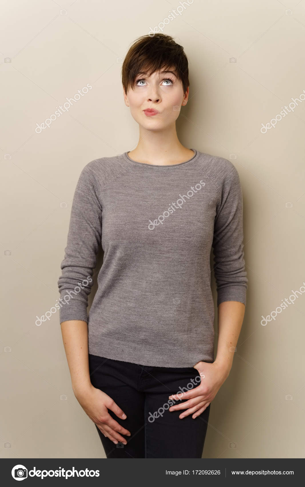 Woman standing chewing her lip Stock Photo by ©racorn 172092626