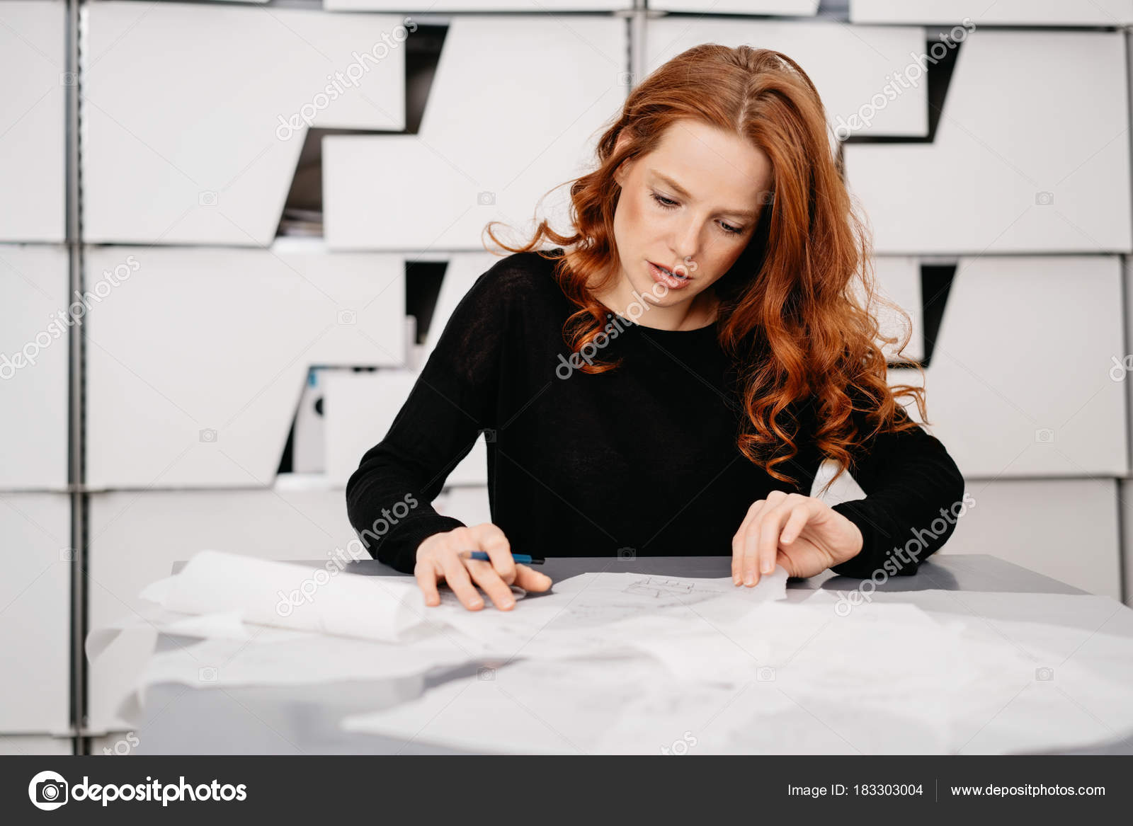 Businesswoman sorting through a pile of papers Stock Photo by ©racorn ...