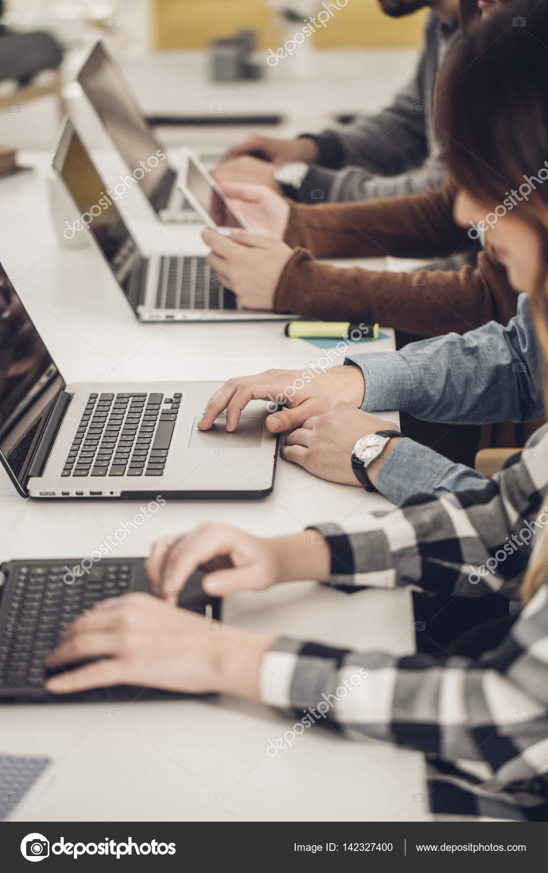 Group of People Typing on Laptops Stock Photo by ©luminastock 142327400