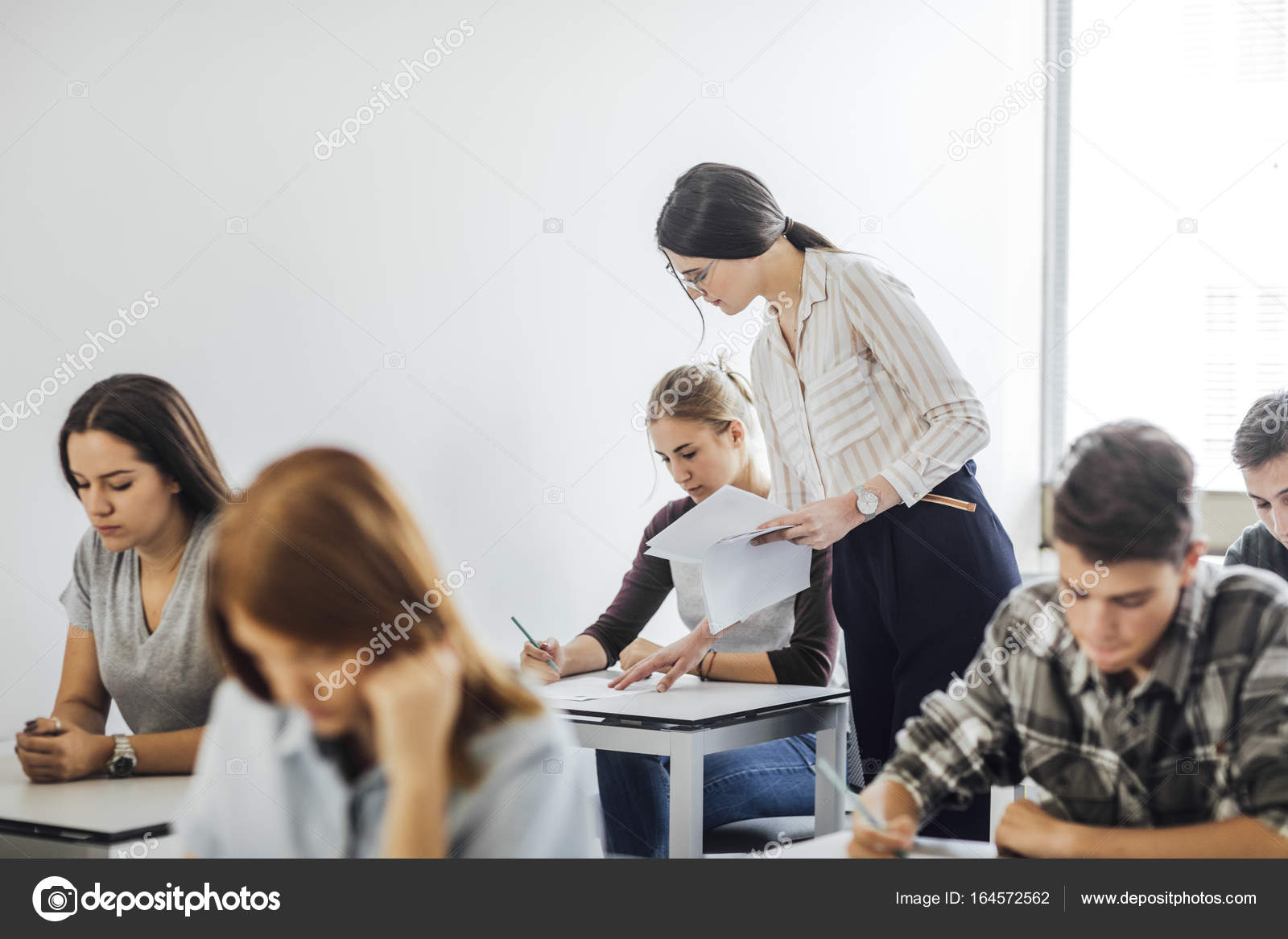 High School Students Doing an Exam — Stock Photo © luminastock #164572562