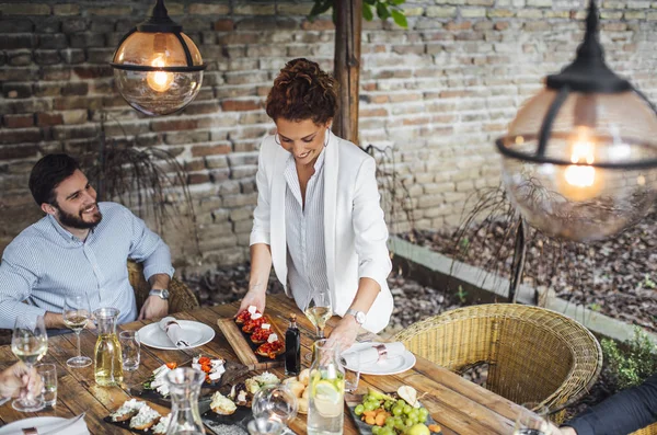 Woman Dinner Party Host Serving Food to Her Friends Stock Photo by ...