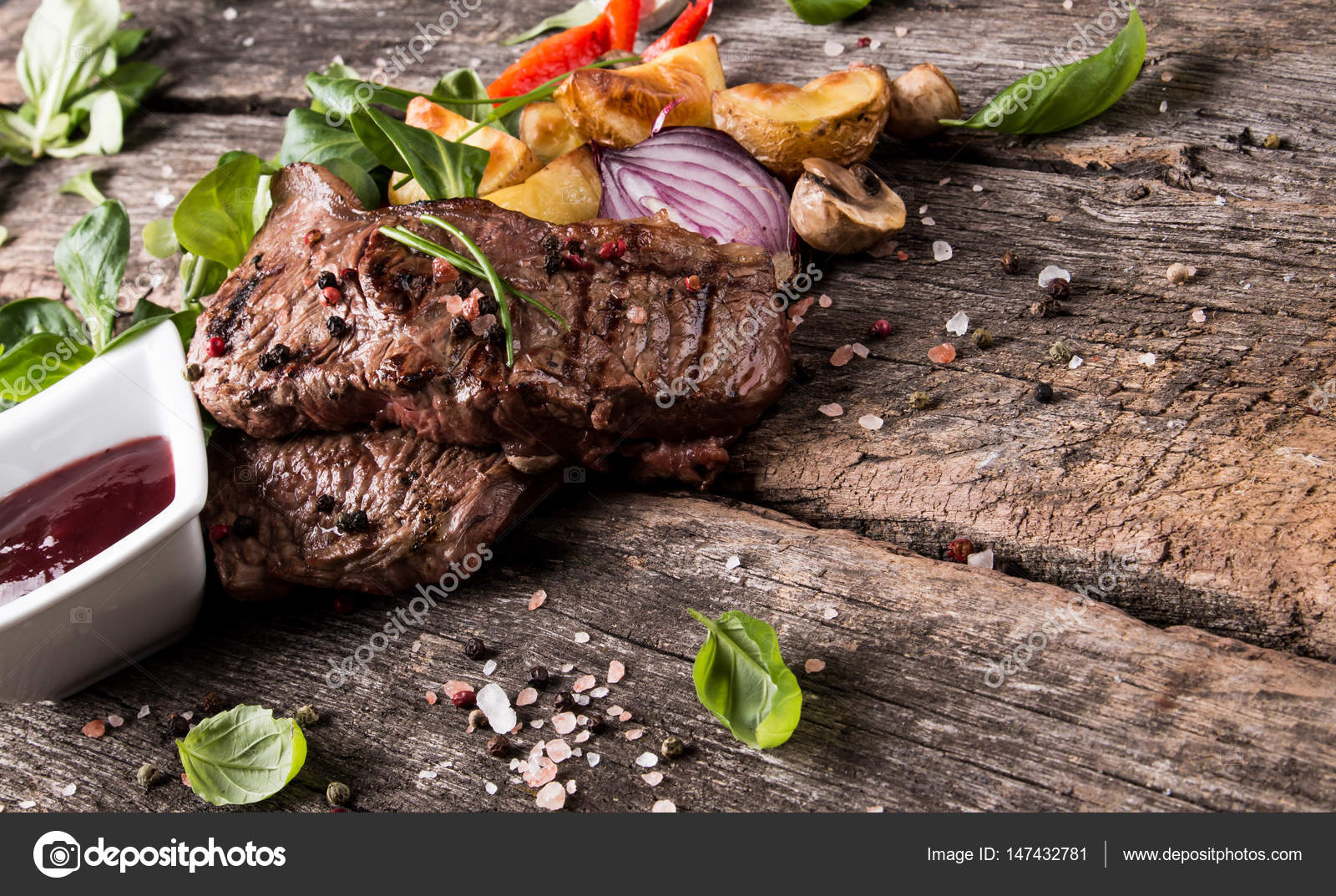 Beef steak on woode table Stock Photo by ©habovka 147432781