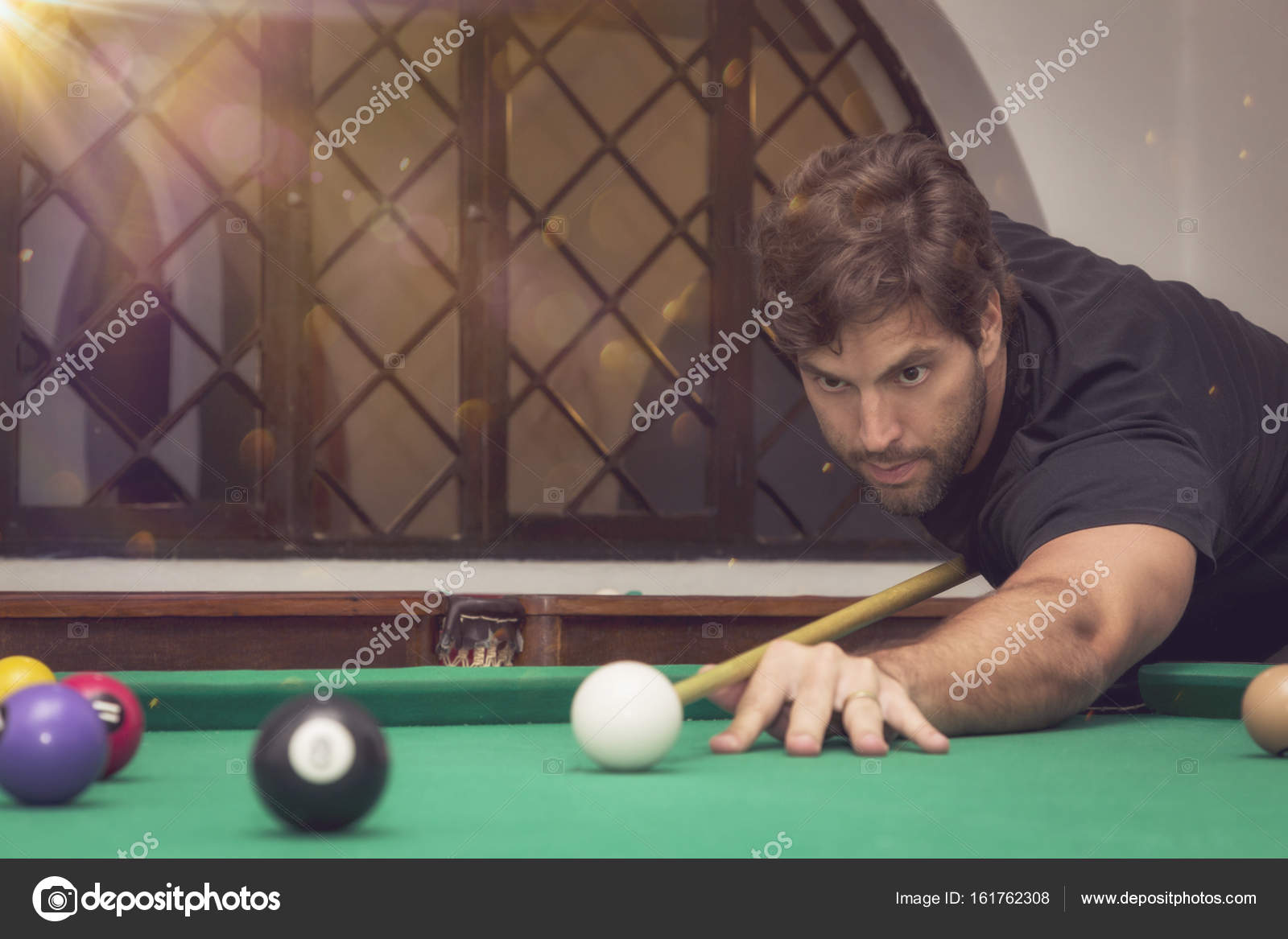 Man playing billiards in a pool table. Stock Photo by ©betochagas 161762308