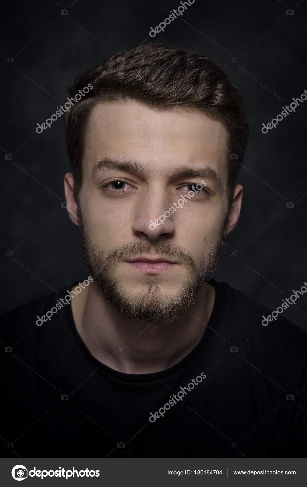 Portrait of a young man with a beard on a dark background. Stock Photo ...