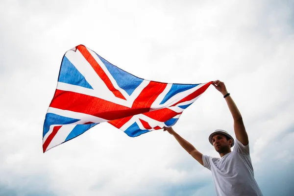 Man holding proudly the British flag. Patriot and supporter of Great ...