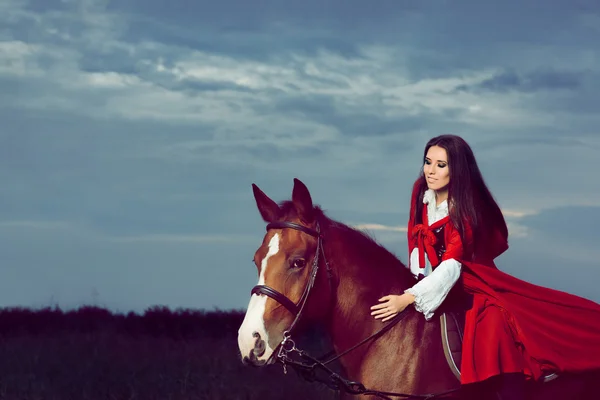 Beautiful Princess with Red Cape Riding a Horse - Stock Image - Everypixel