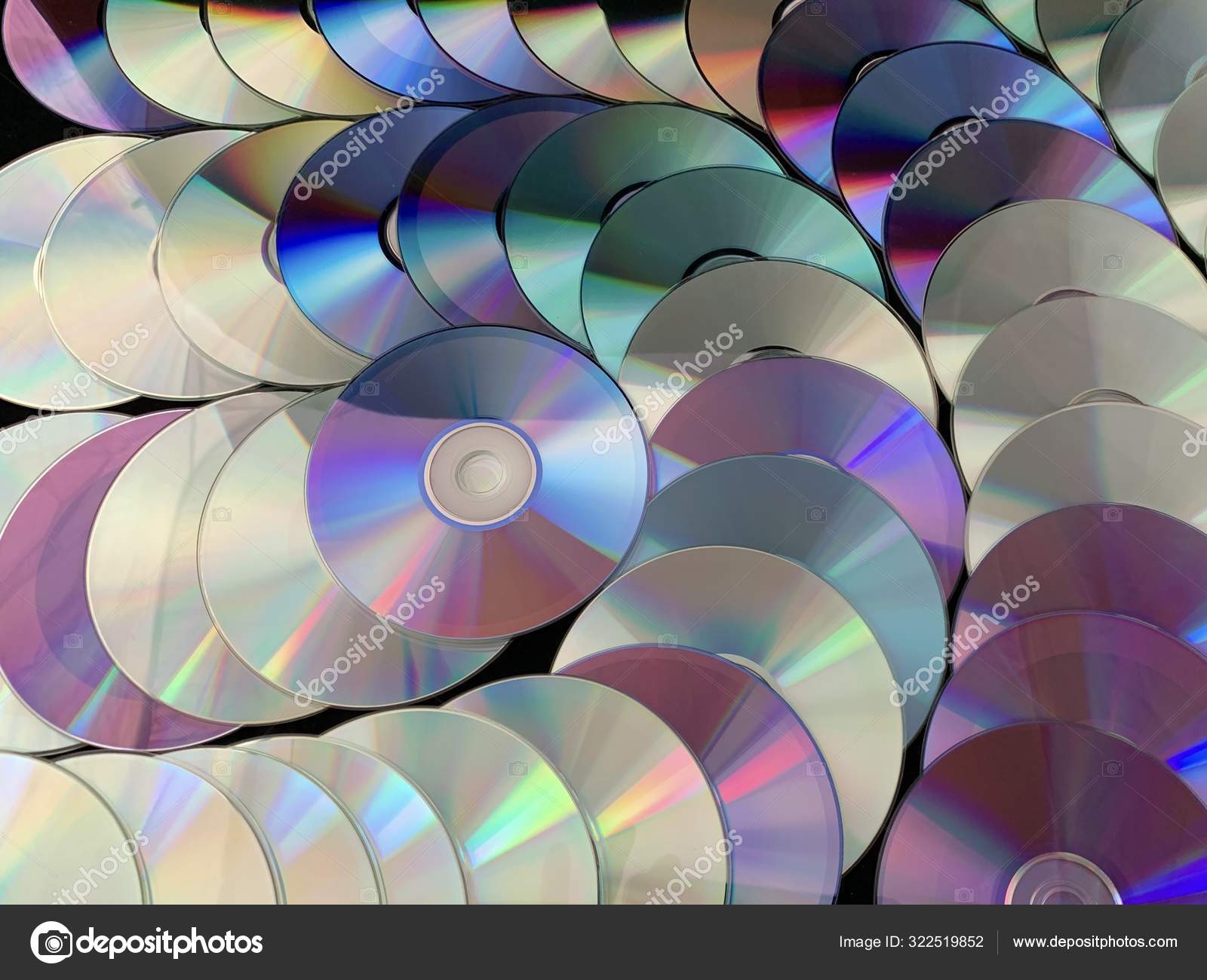 Background texture: a lot of computer disks. Music CDs on a black ...