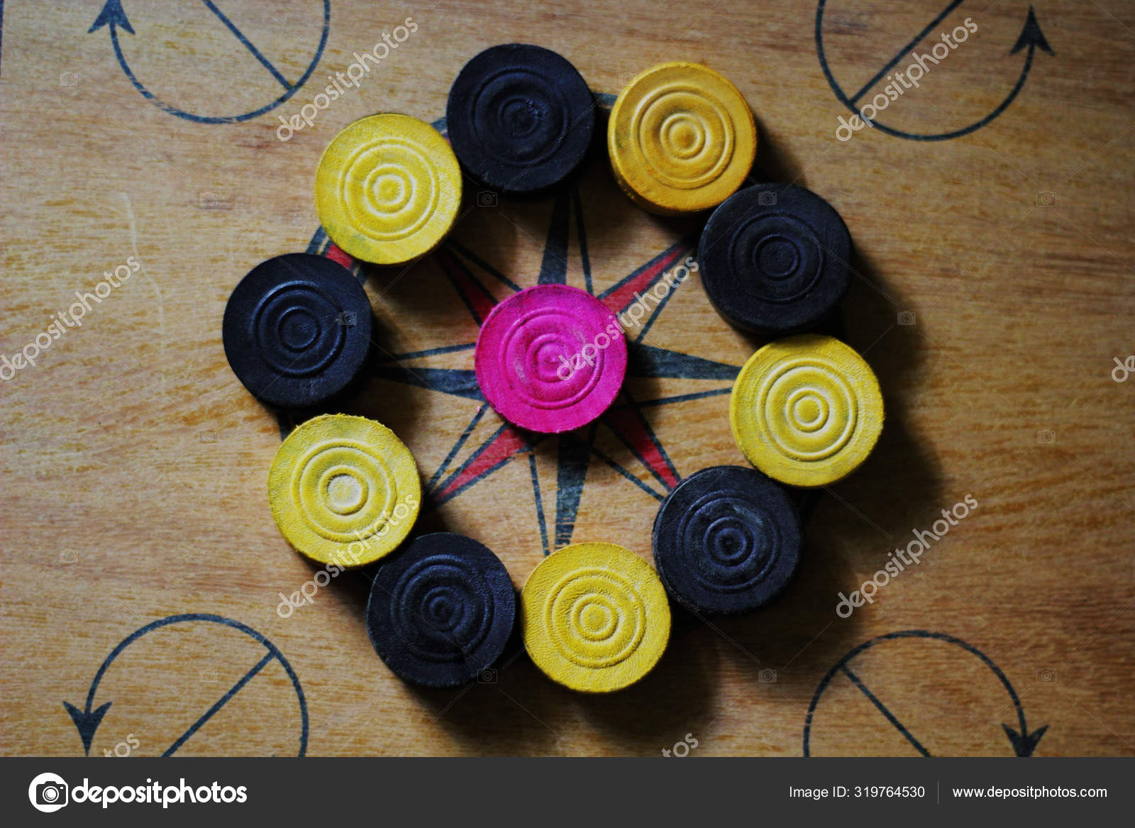 A game of carom set and ready to play.A game of carrom with pieces ...