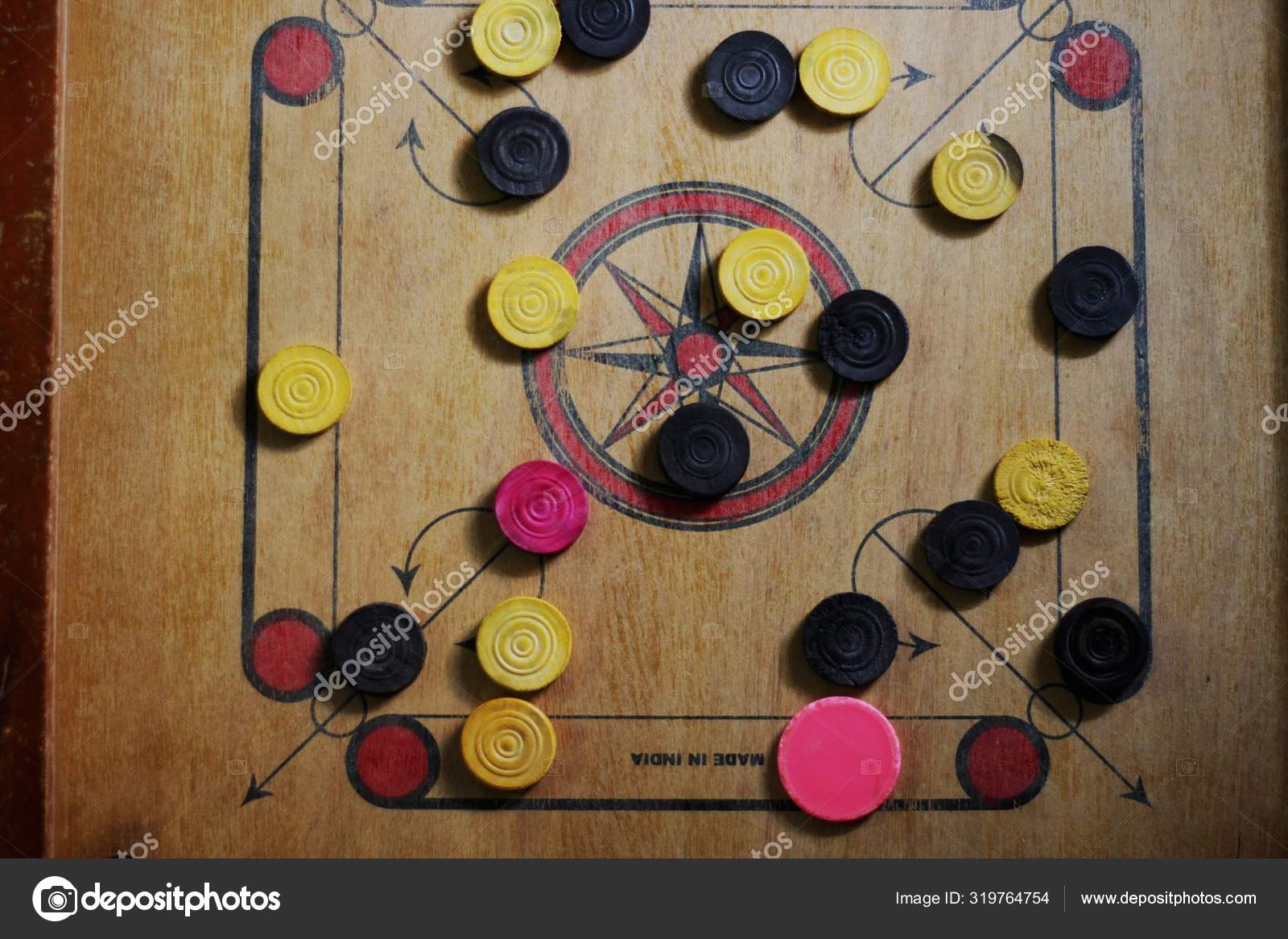 A game of carrom with pieces carrom man on the board carom - stacking.A ...