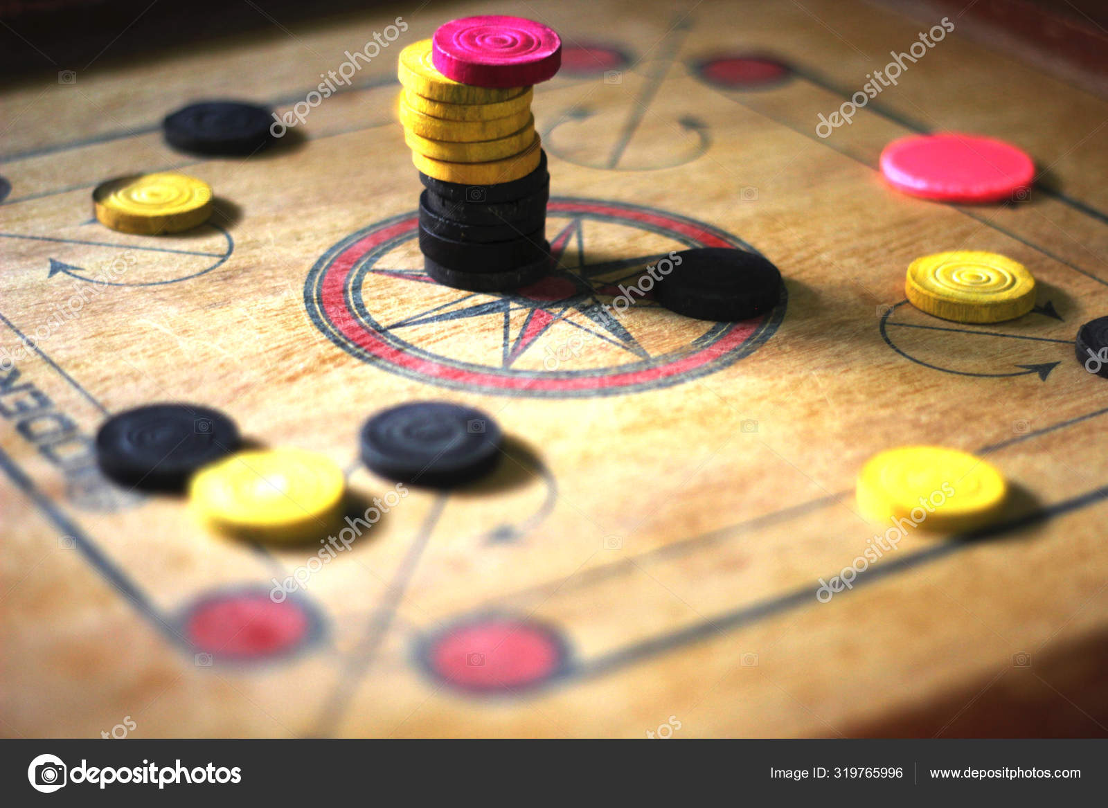 A game of carrom with pieces carrom man on the board carom - stacking.A game of carom set and ...