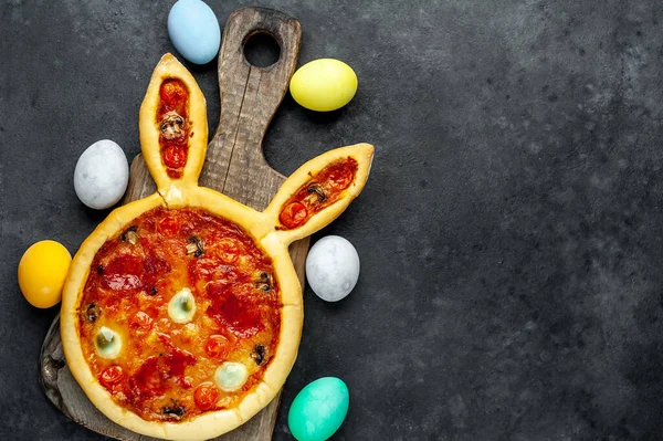 Festive Easter pizza in the form of a rabbit with eggs, multi-colored ...