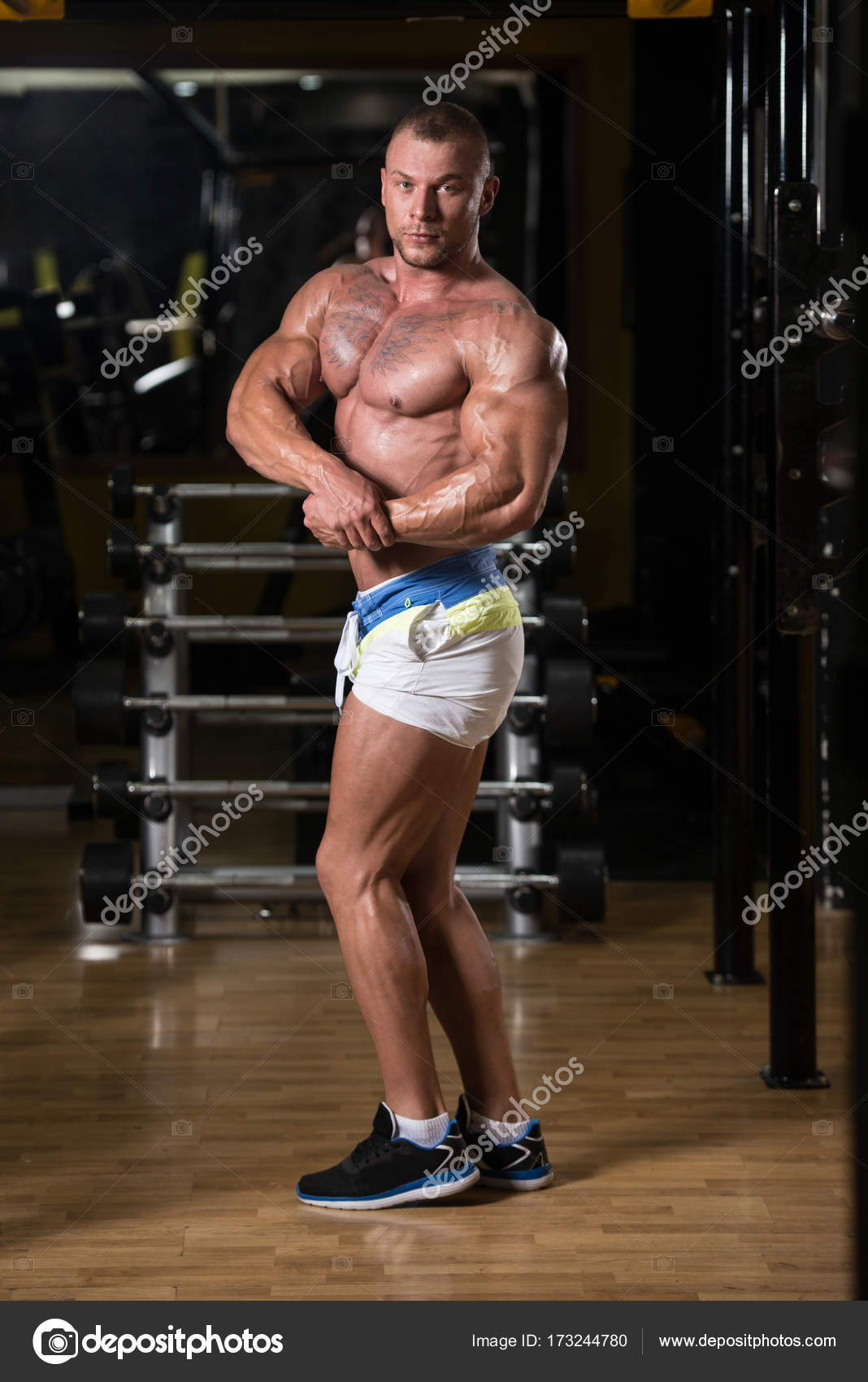 Serious Bodybuilder Standing In The Gym — Stock Photo © ibrak #173244780