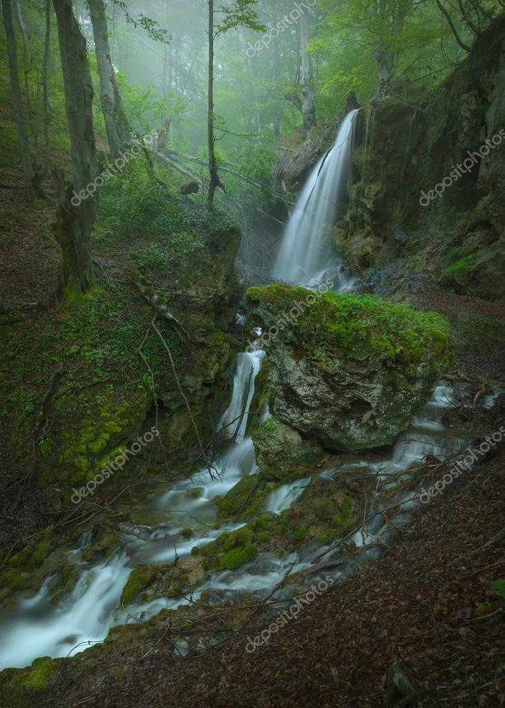 Big rock and beautiful waterfall at misty morning — Stock Photo ...