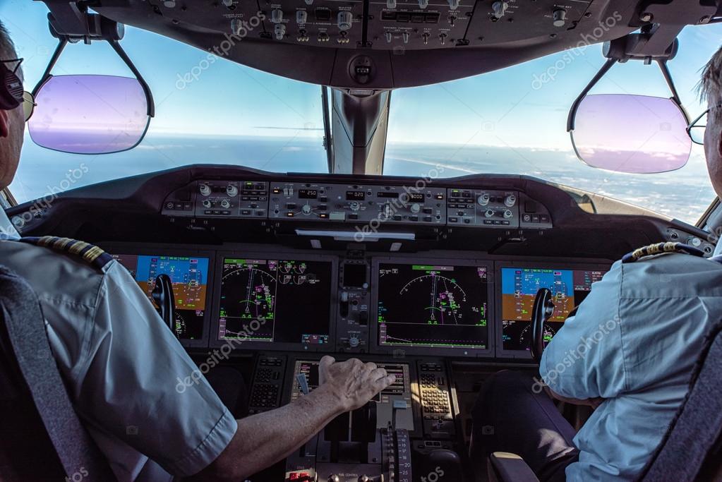 Pilot and copilot in commercial plane Stock Photo by ©atosan 127746522
