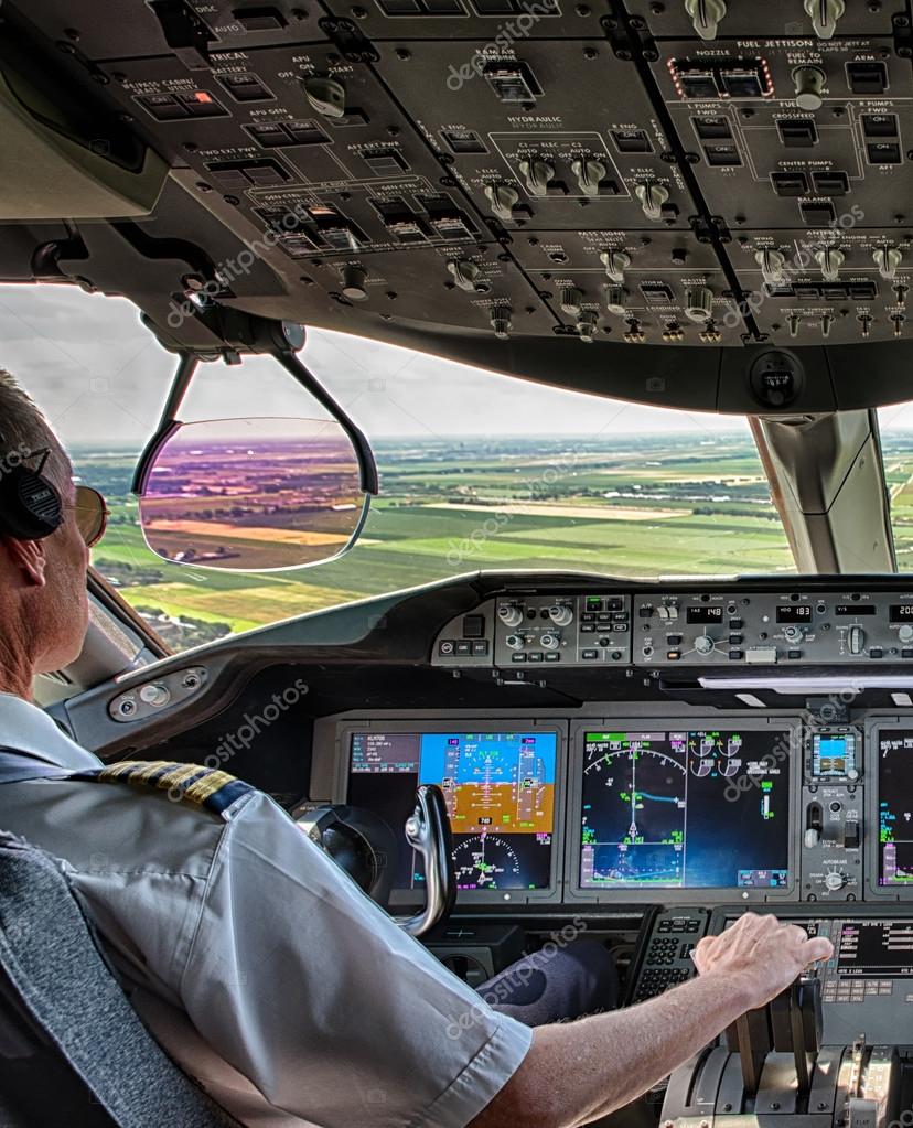 Pilot and copilot in commercial plane Stock Photo by ©atosan 127746970