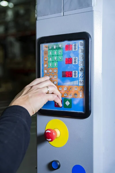 A punching machine in a cardboard boxes factory production hall. Paper ...