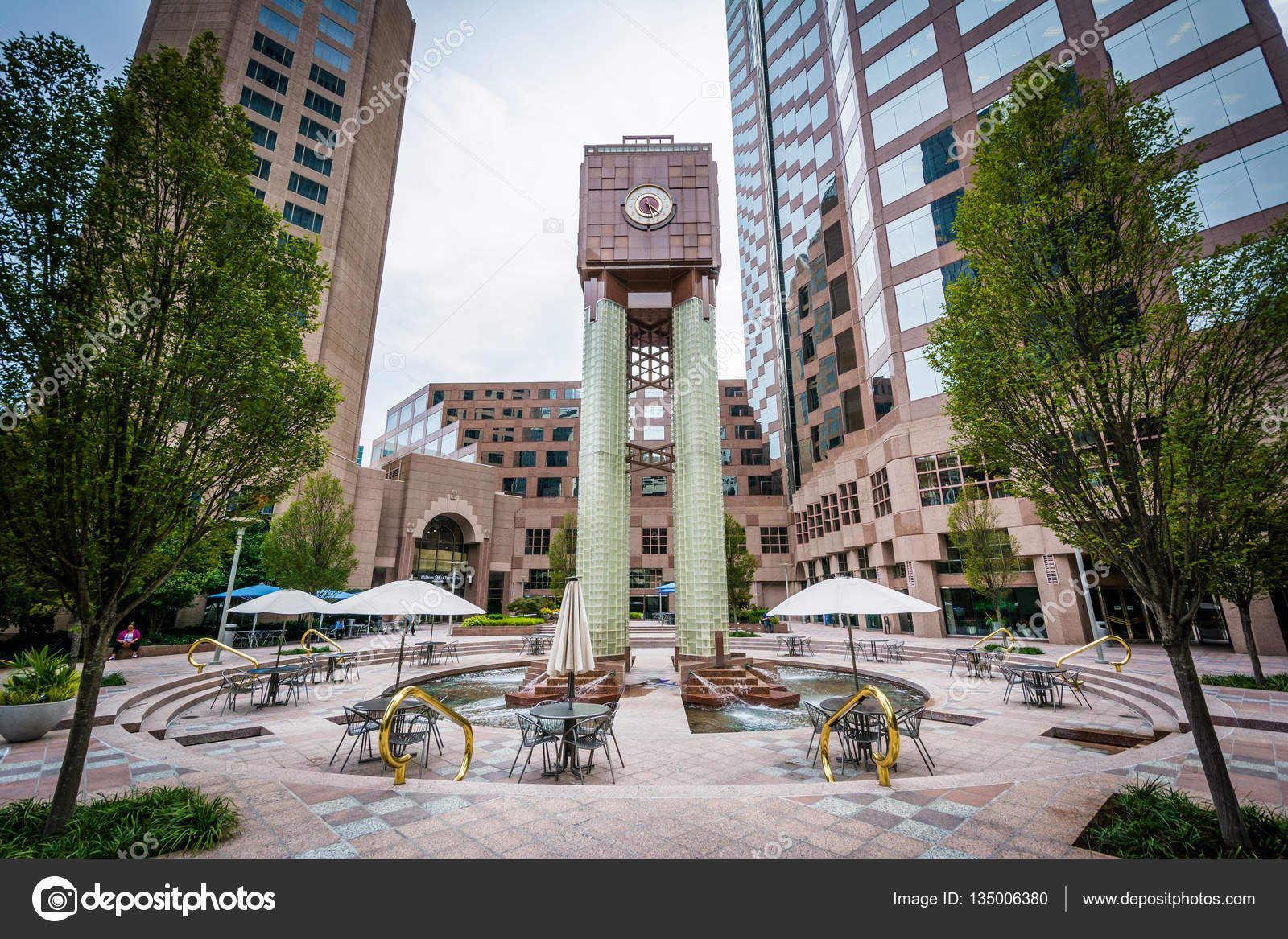 Modern buildings and park with fountain and tables in Uptown Cha ...