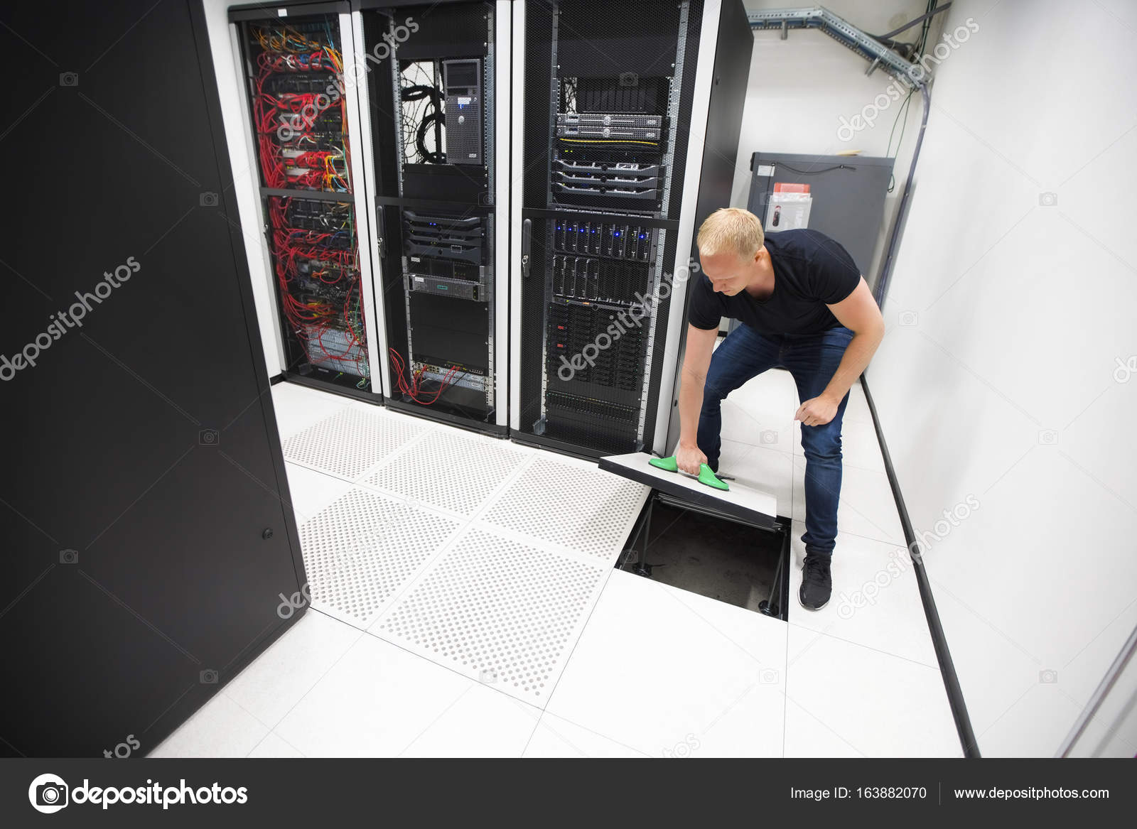 Computer Engineer Lifting Floor Tile Using Suction Cups In Datac Stock ...