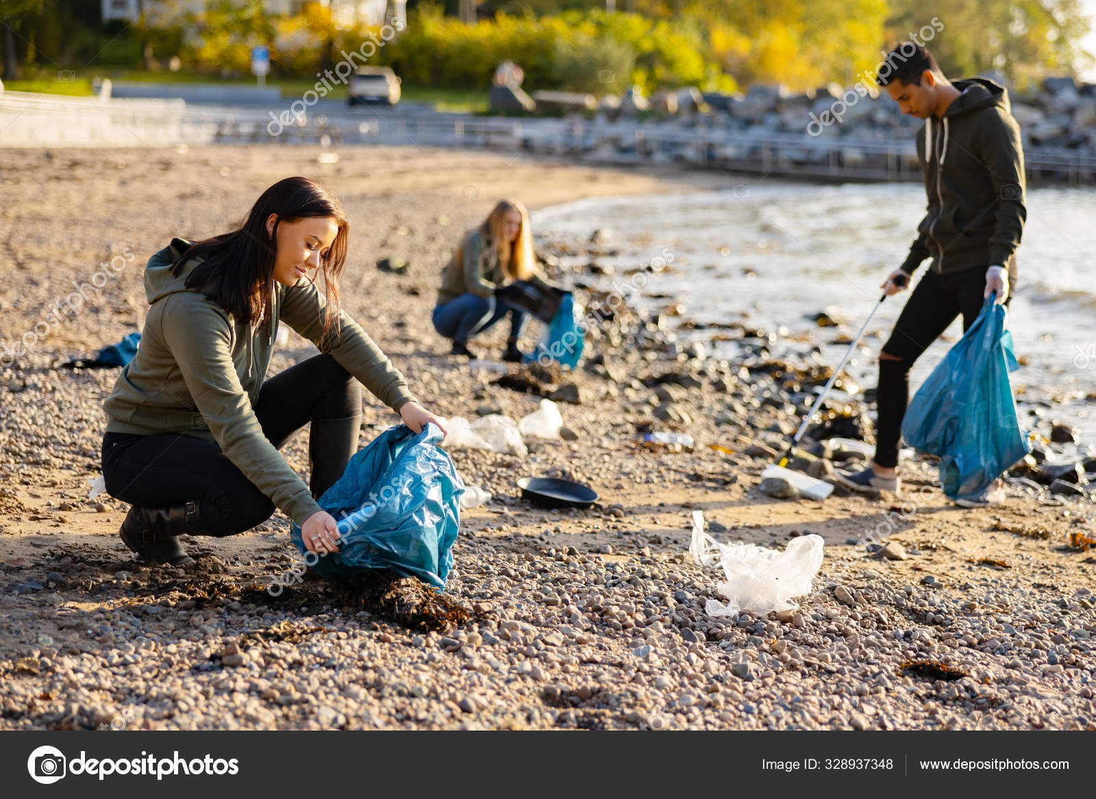 People Picking Up Trash On The Beach People Picking Up Trash On The Beach