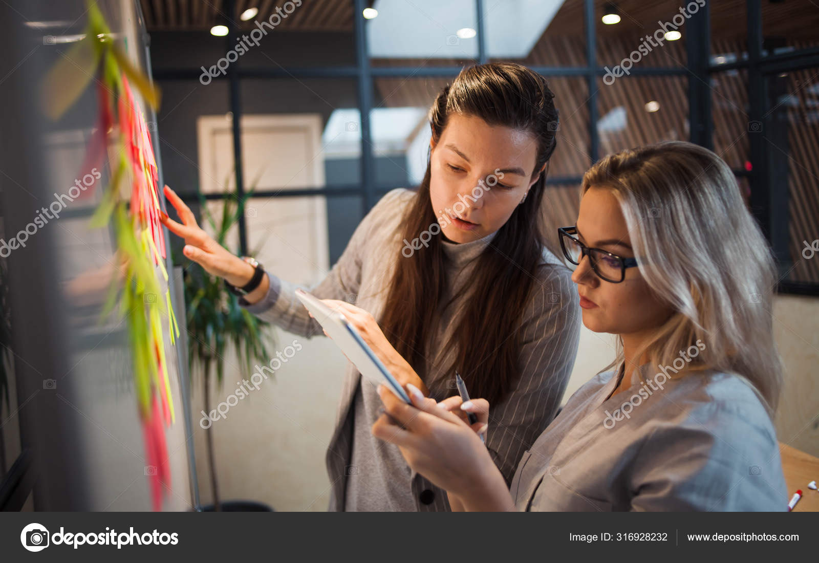 Teamwork, project management, agile methodology. Two young business ...