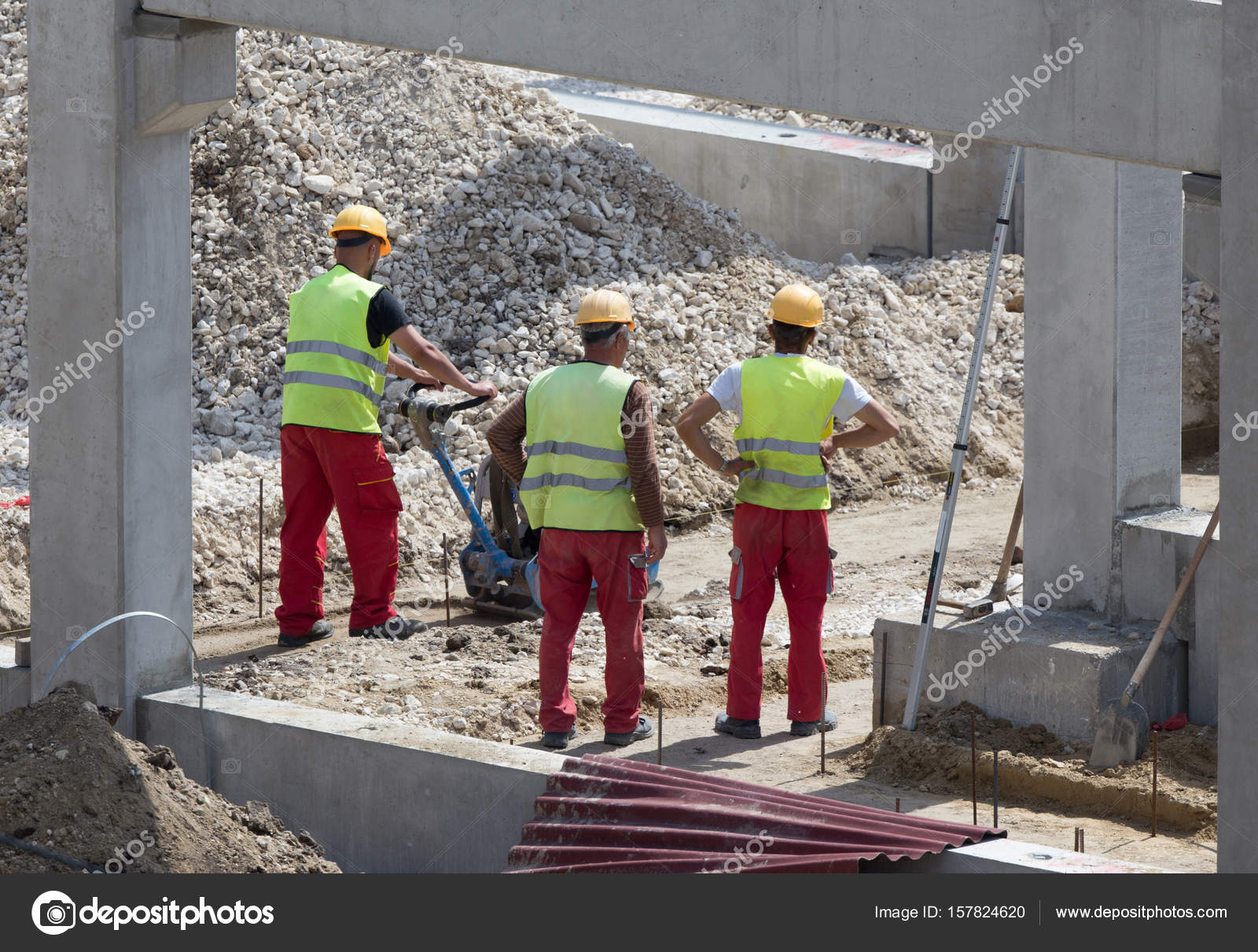 Construction workers on building site Stock Photo by ©budabar 157824620
