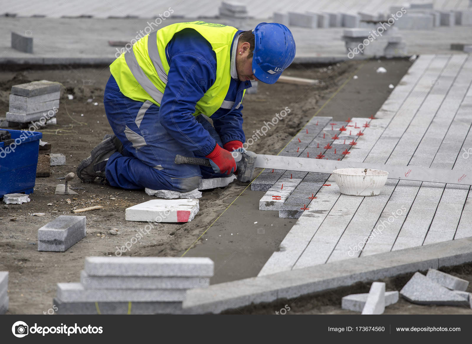 Worker laying paving stones – Stock Editorial Photo © kataklinger ...
