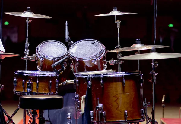 Drum set in the concert hall. Drums in the dark. Percussion instruments ...