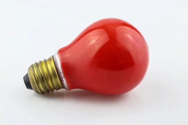 Red light bulb with yellow thread separated on white background ...
