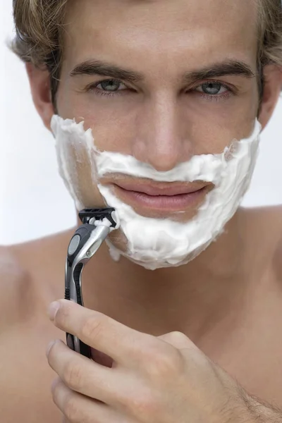 young man shaving face - Stock Image - Everypixel