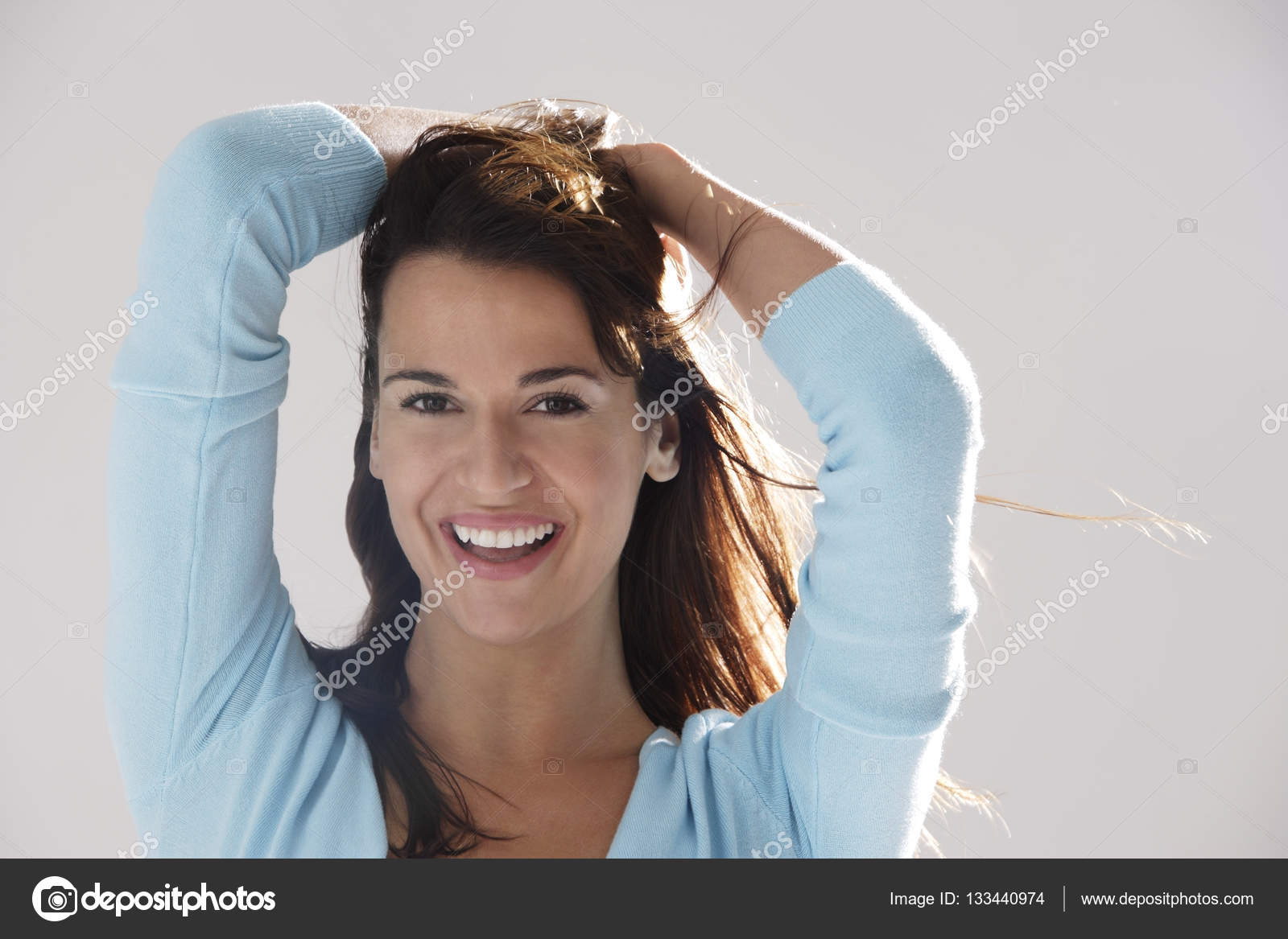 Woman with hands in hair — Stock Photo © MicrostockAsia #133440974
