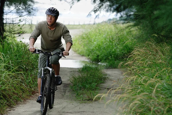 Man cycling on nature path - Stock Image - Everypixel