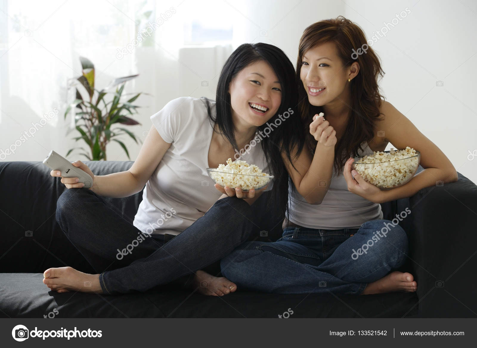 Women enjoying popcorn — Stock Photo © MicrostockAsia #133521542