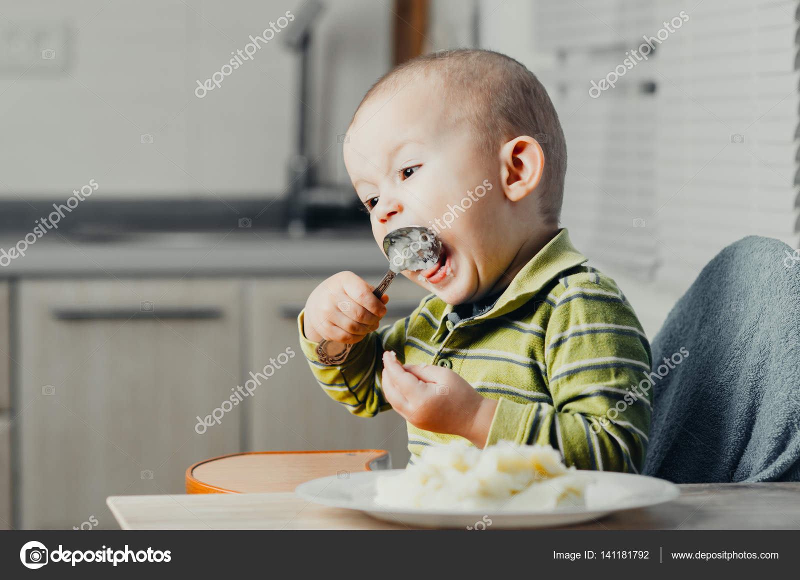 The child eats mashed potatoes ⬇ Stock Photo, Image by © Komokvm #141181792