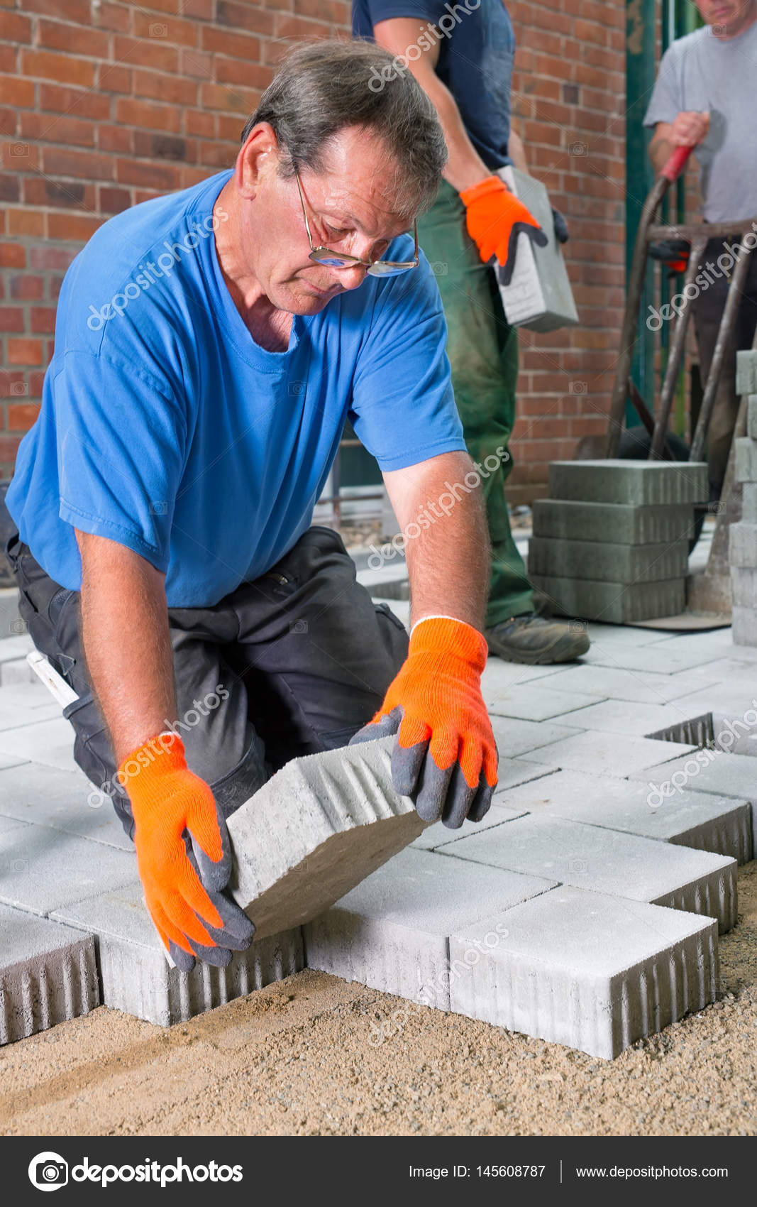 Builders laying paving stones — Stock Photo © belahoche #145608787