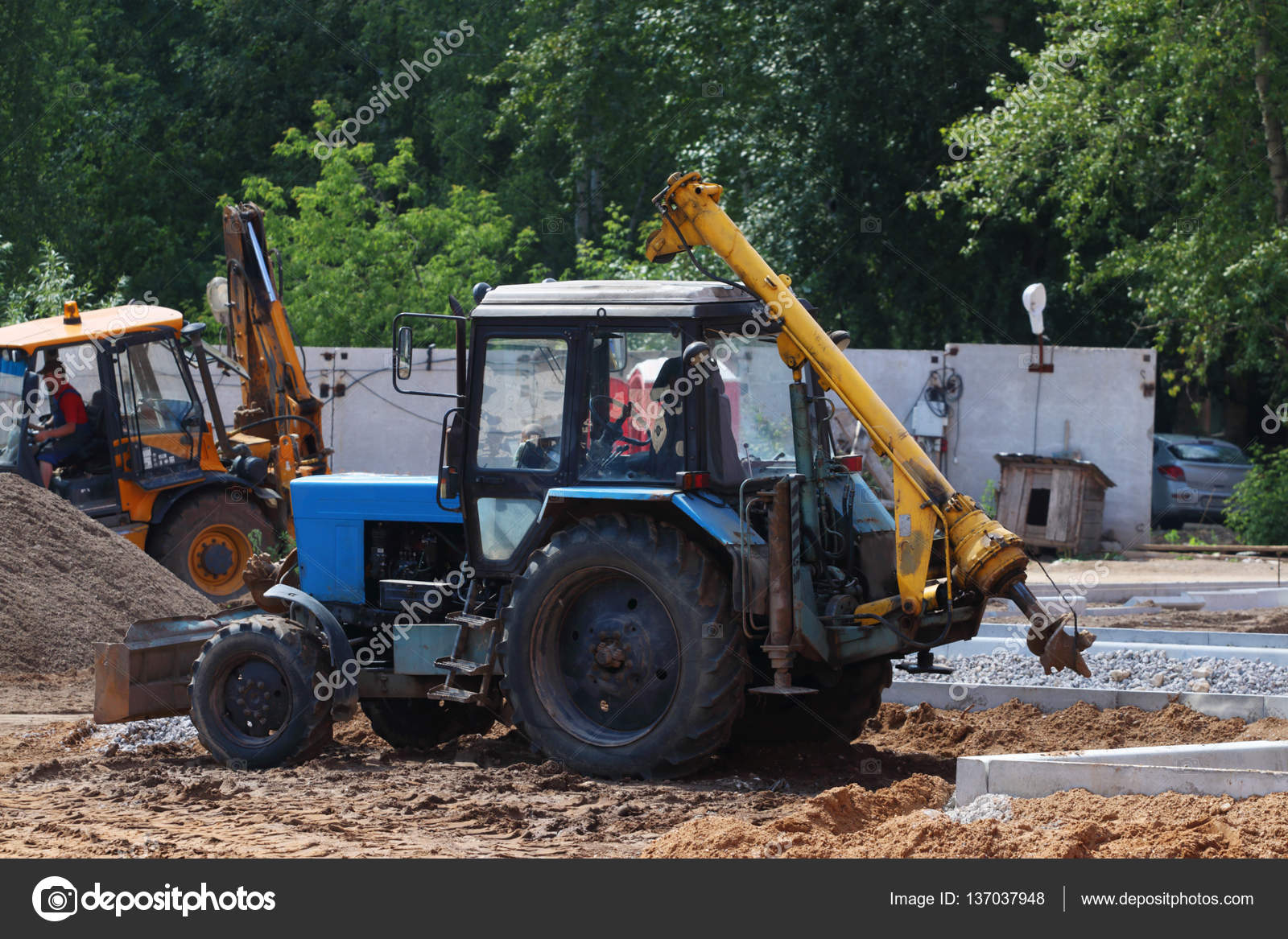 Two tractors work on construction site with gravel and sand at s Stock ...