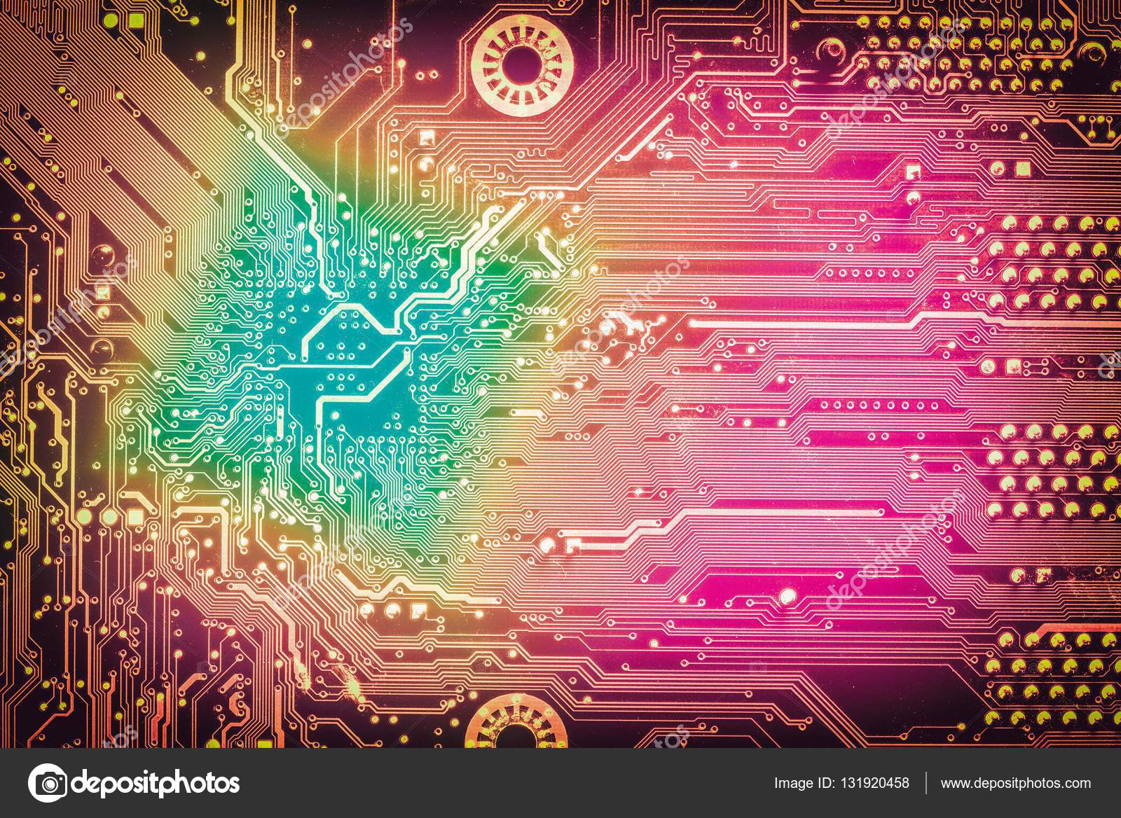 Close up of computer circuit board, toned in pink and green colors ...