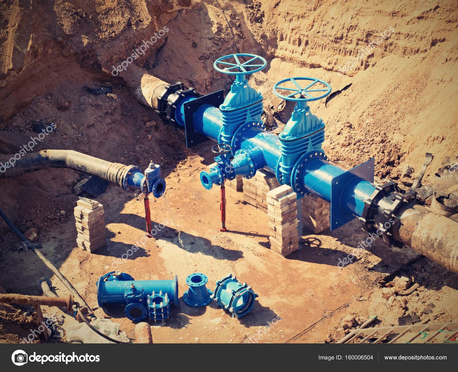 Oil, gas, water industry. Wellhead with valve armature underground. Dug ...