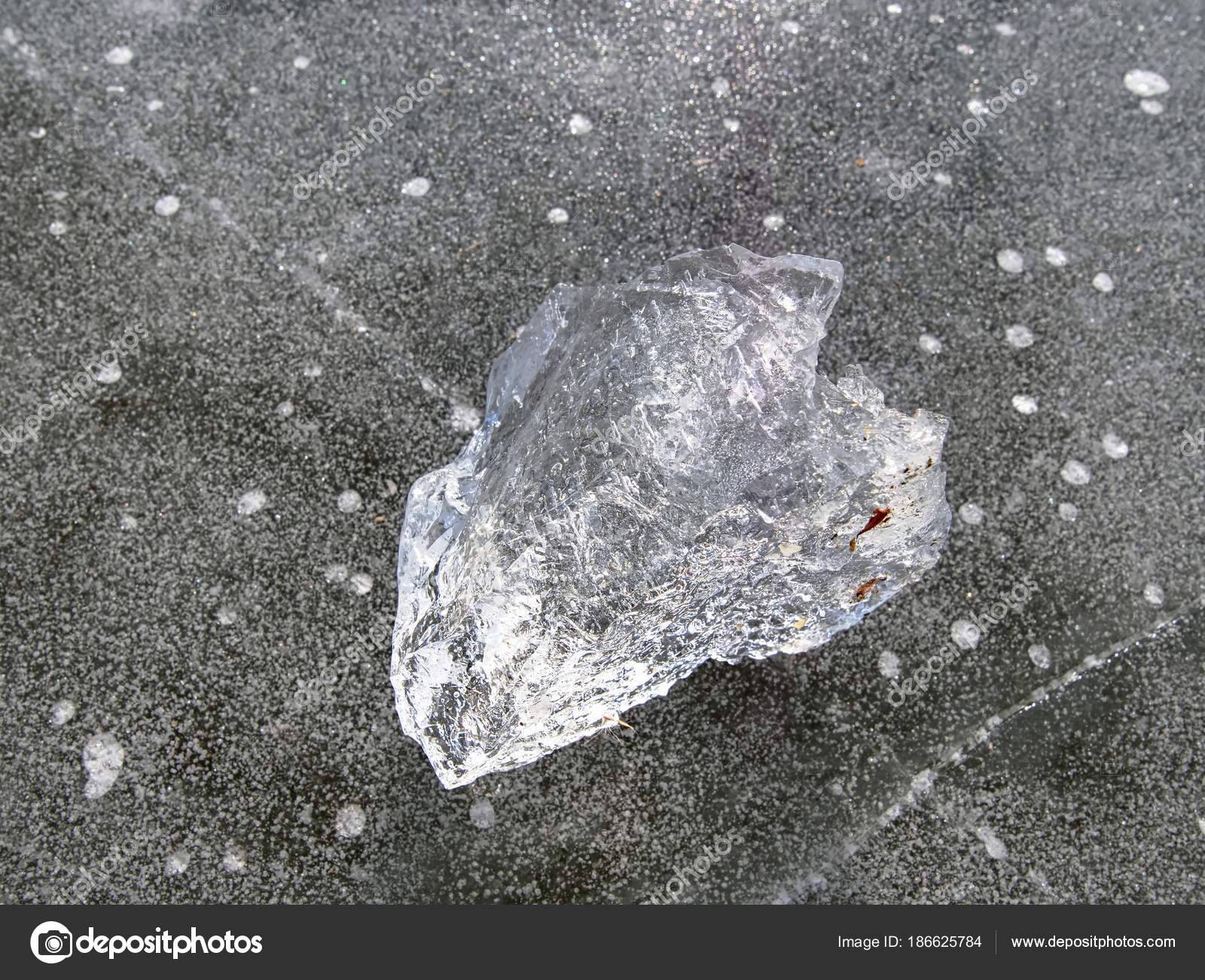 Transparent ice piece on the lake. Crystal clear piece of ice squeezed ...