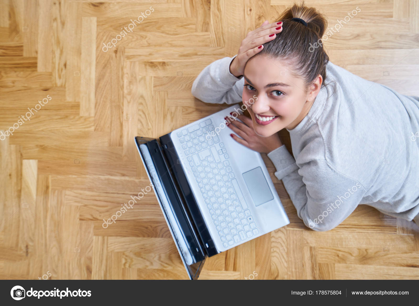 Woman Lying Floor Using Laptop Stock Photo by ©Ancikainfot 178575804