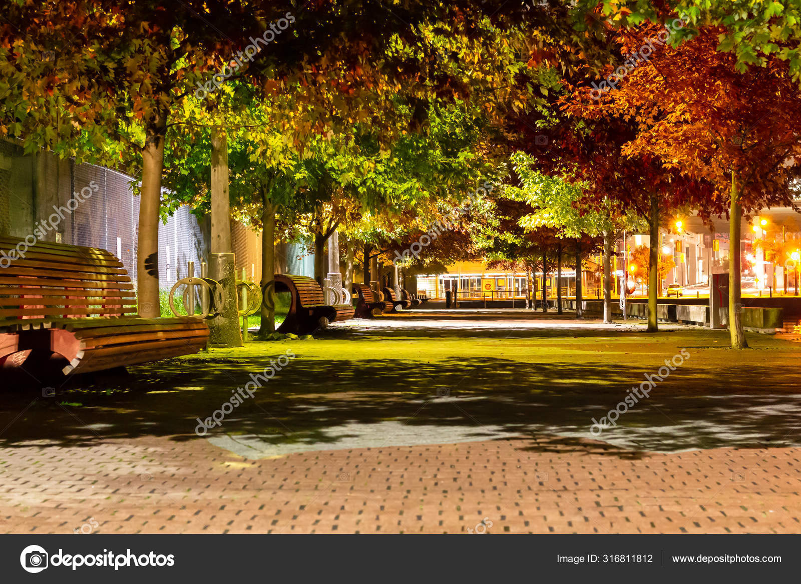 An interlock park path and treed in area along the lake shore at Stock ...