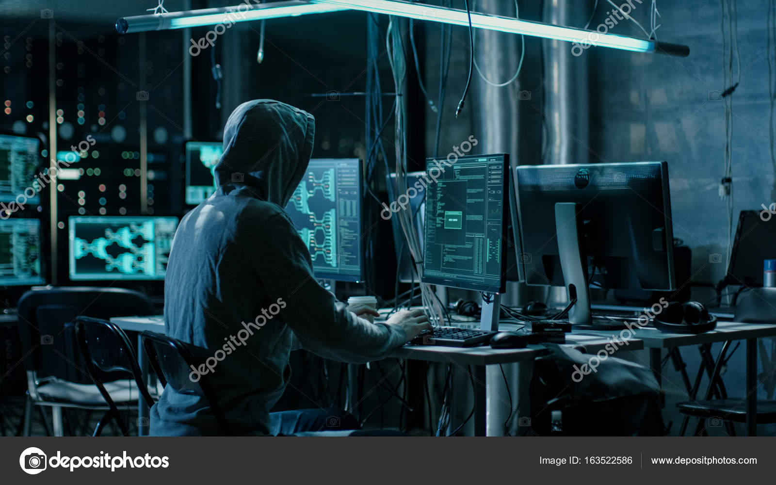 Hooded Hacker Using His Comuter with Different Information to Br Stock ...