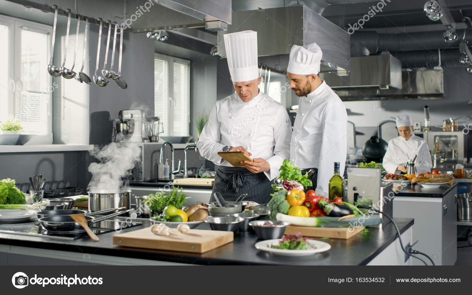 Two Famous Chefs Discuss Their Video Blog while Using Tablet Com ...