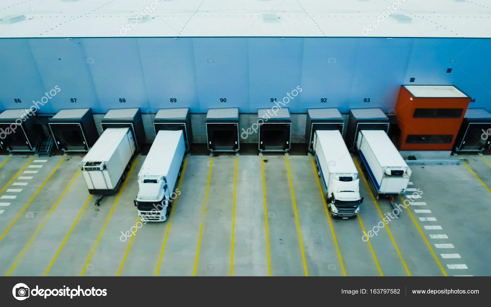 Aerial Side Shot of Industrial Warehouse Loading Dock where Many Stock ...