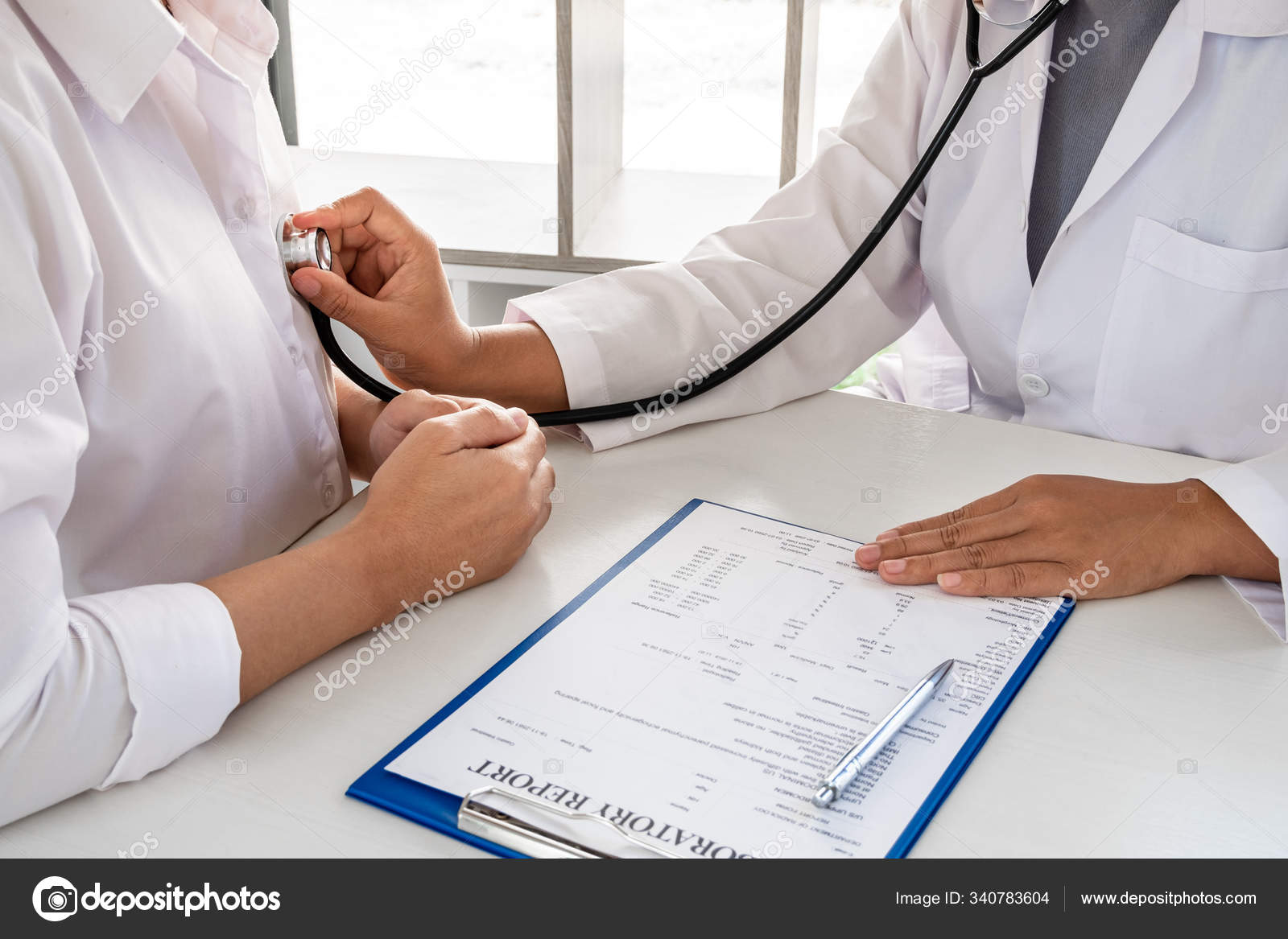 Female doctors perform a pulse examination using a stethoscope. Initial ...
