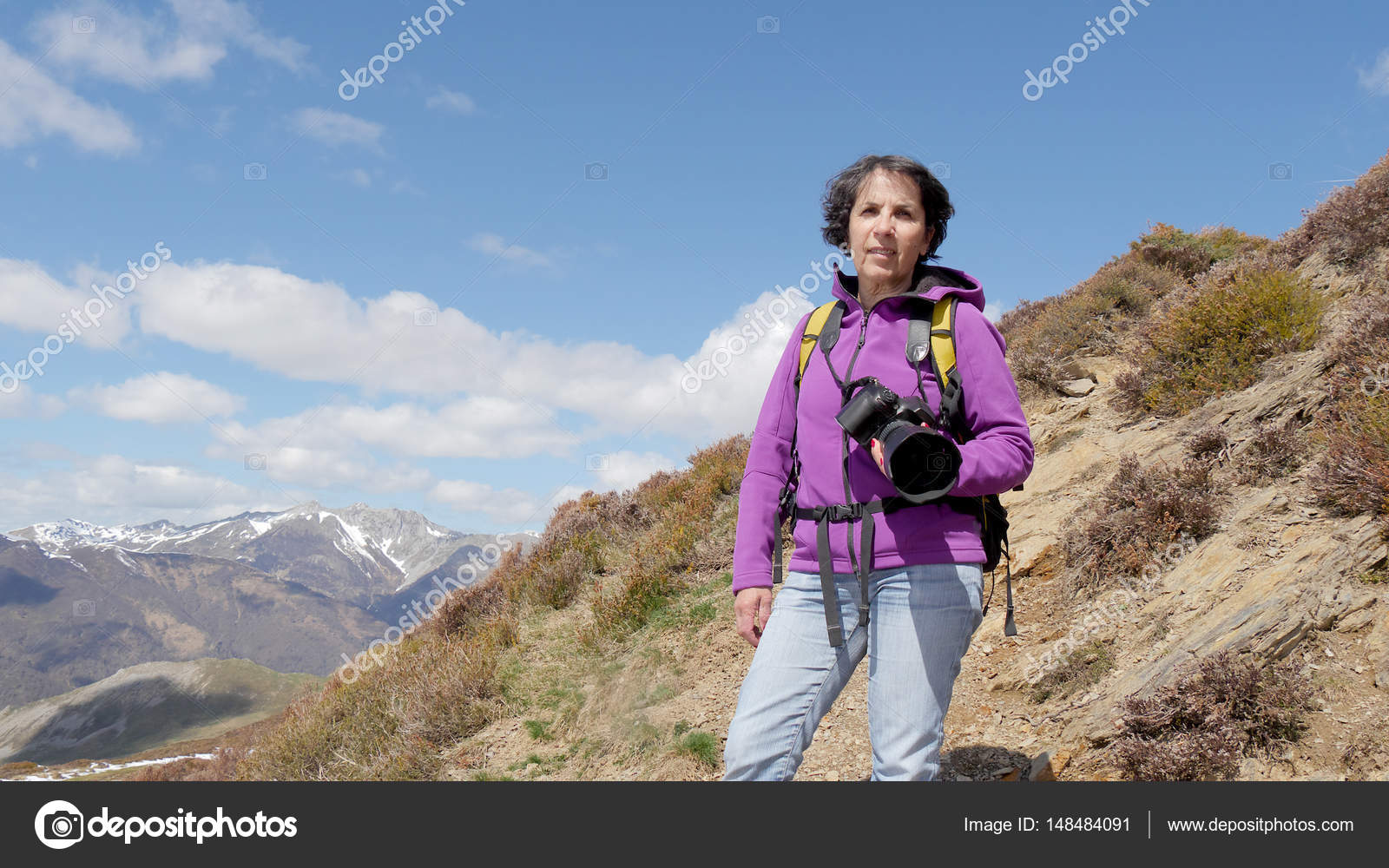 Hiker with camera and backpack taking picture of beautiful mount ⬇ ...