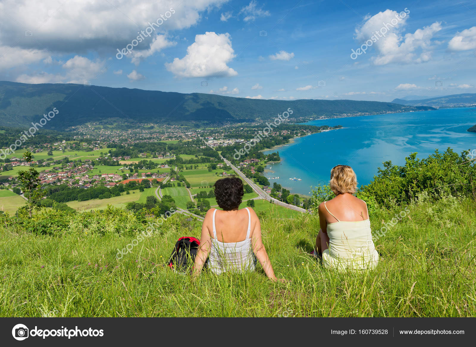 Two women watching view of Lake Annecy — Stock Photo © philipimage ...