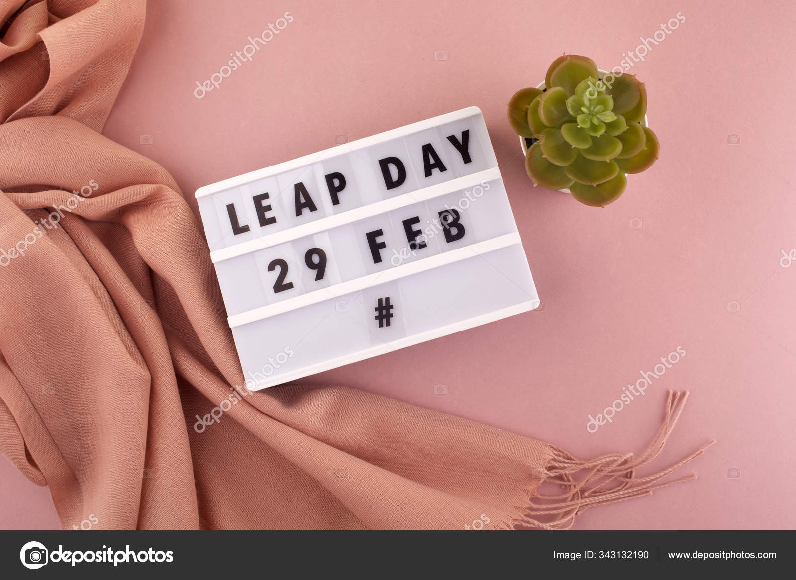 White block calendar present date 29 and month February and plant on ...