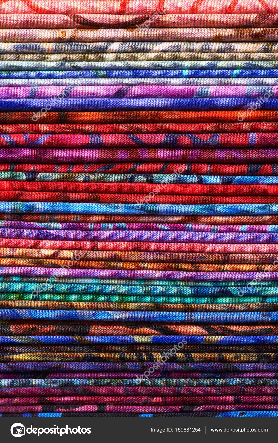 Stack of colorful batik fabrics as a vibrant background image — Stock ...