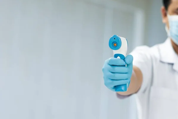 Medical staff use temperature measuring devices for patients suspected ...